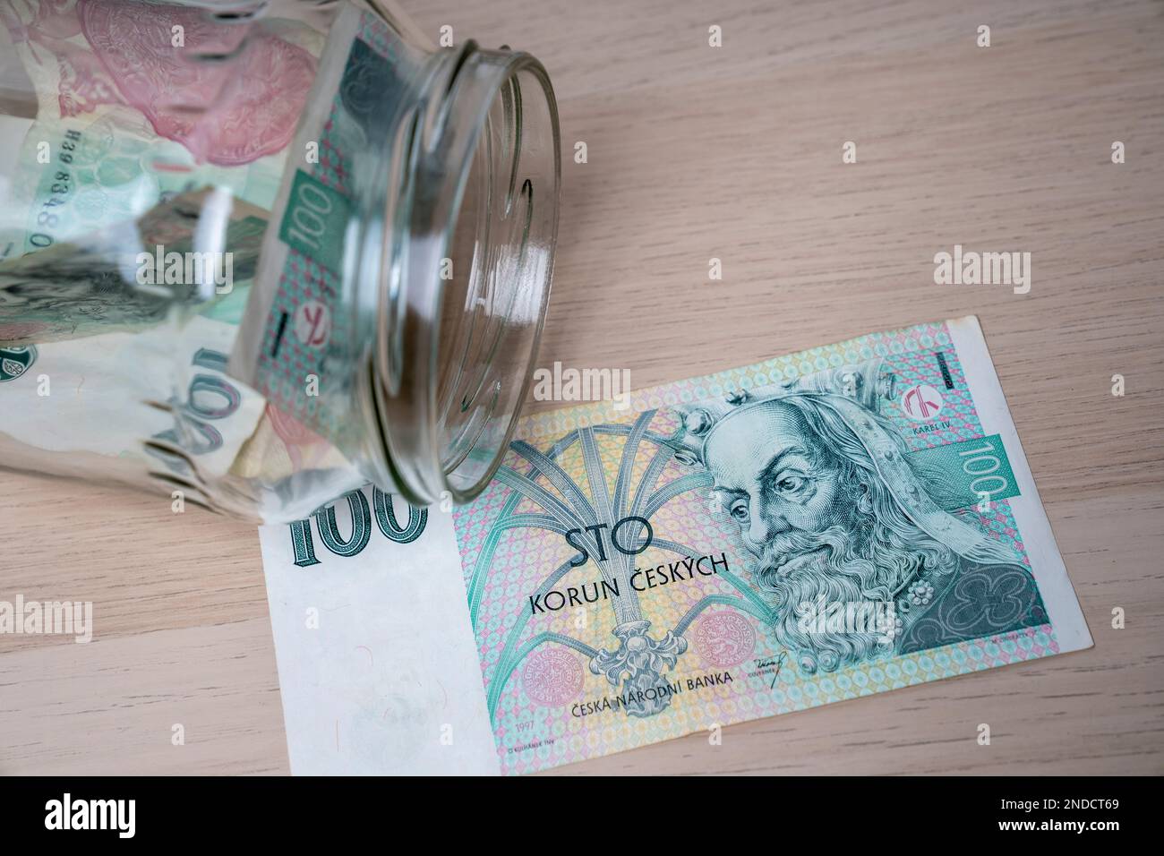 100 korun banknote of the Czech Republic banknotes in the glass jar ...
