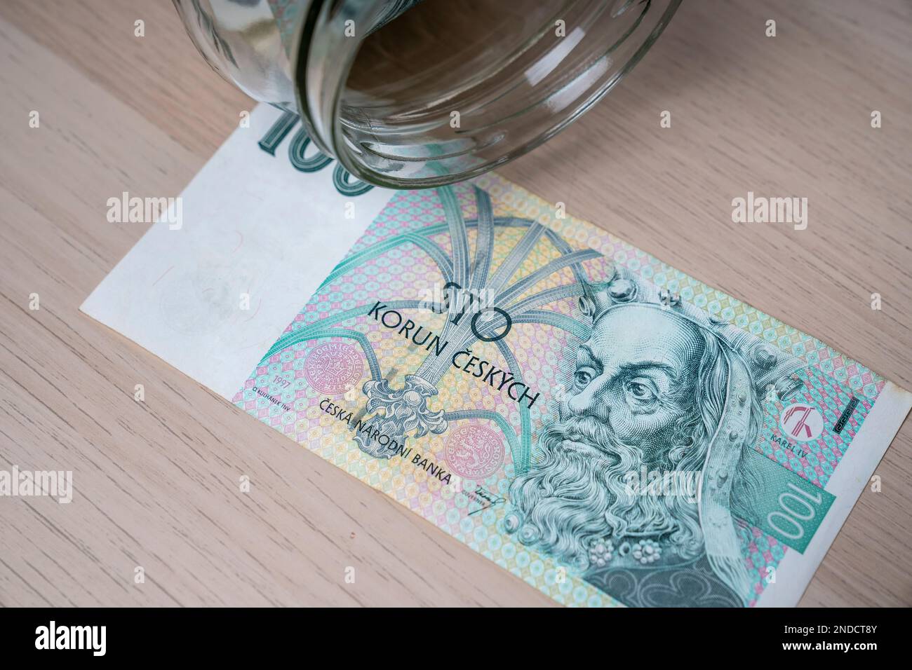 100 korun banknote of the Czech Republic banknotes in the glass jar ...