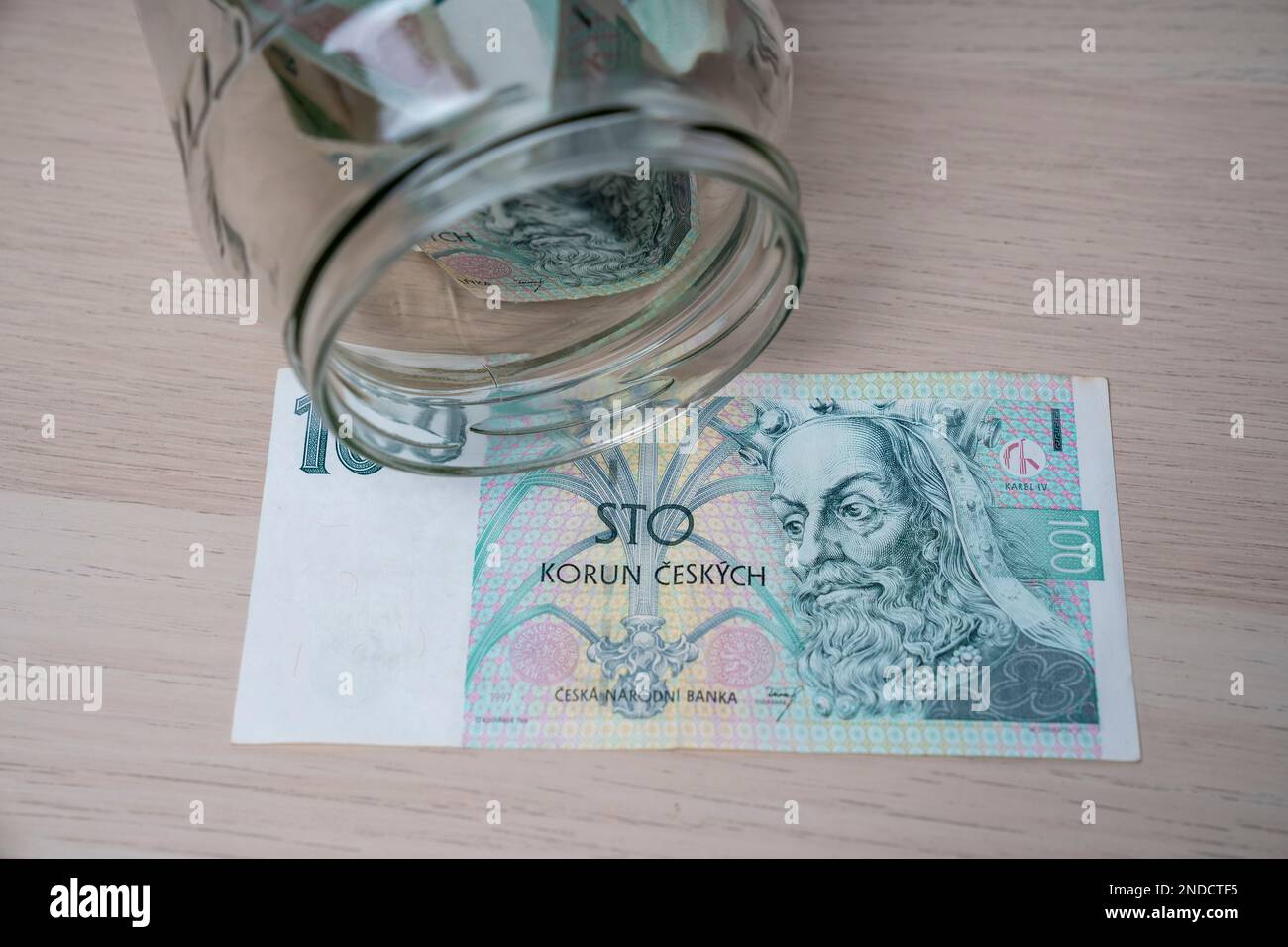 100 korun banknote of the Czech Republic banknotes in the glass jar ...