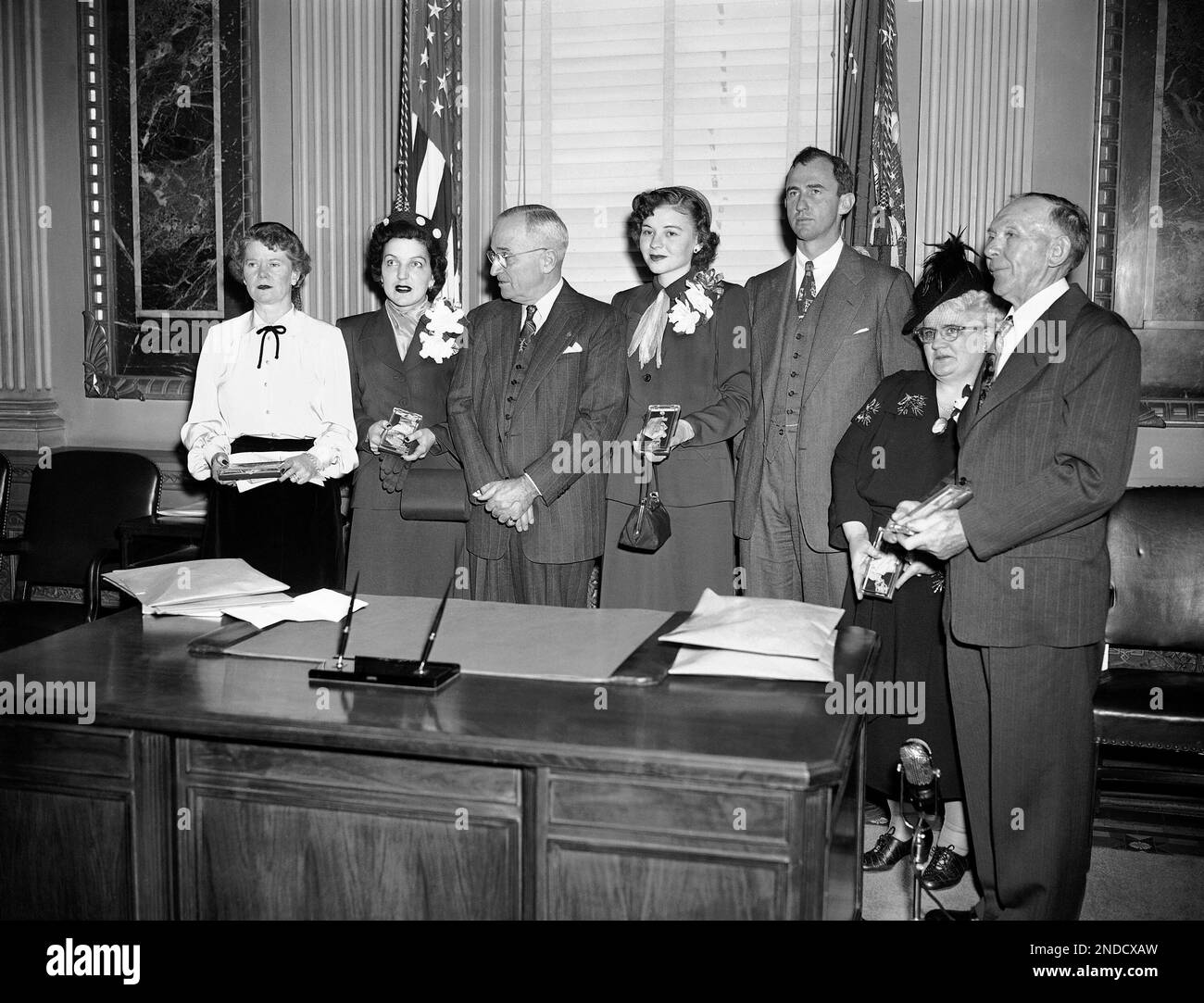 President Harry Truman and Army Secretary Frank Pace pose with members ...