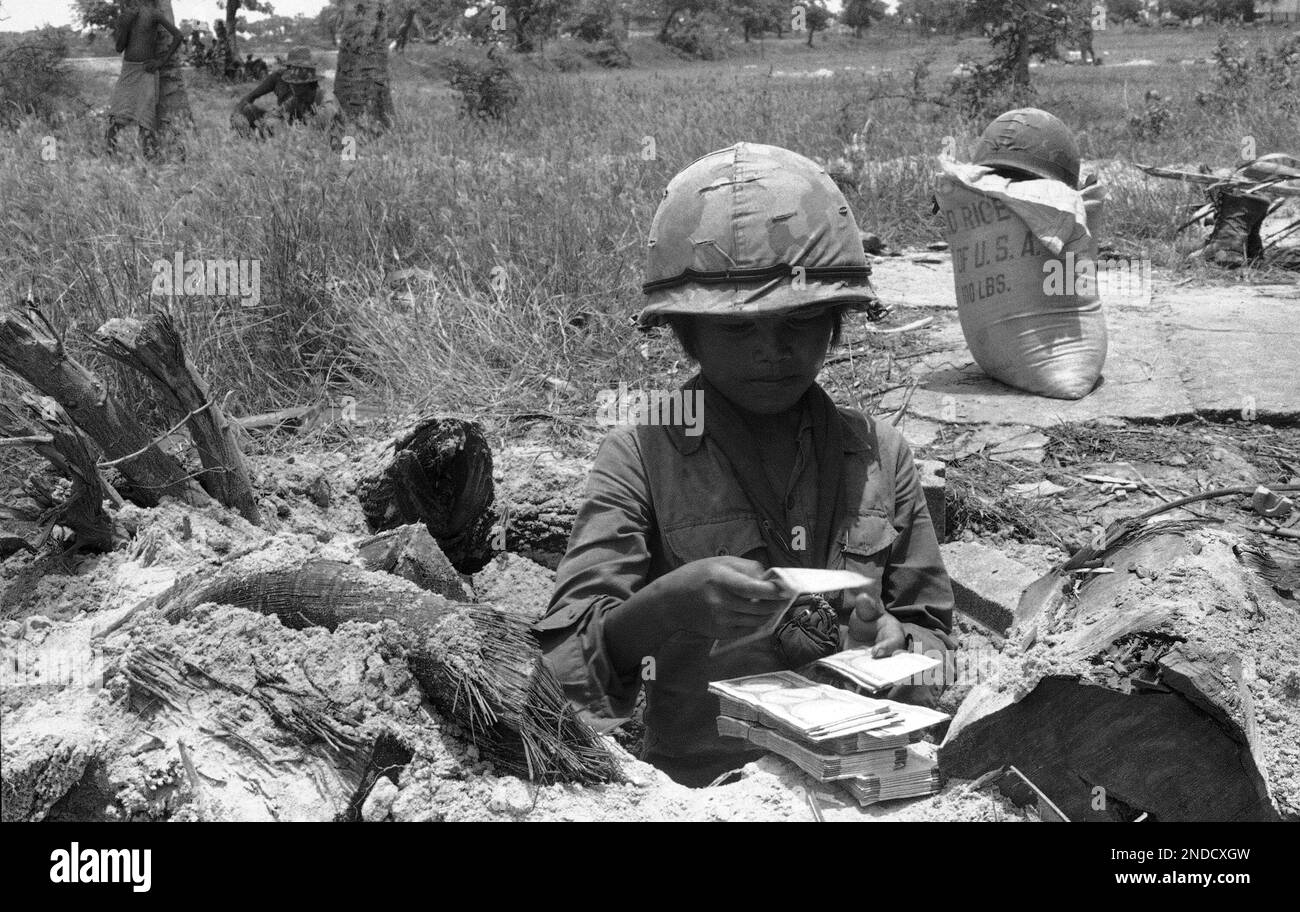 A young Cambodian government soldier stands in a foxhole, at Ang Snoul ...