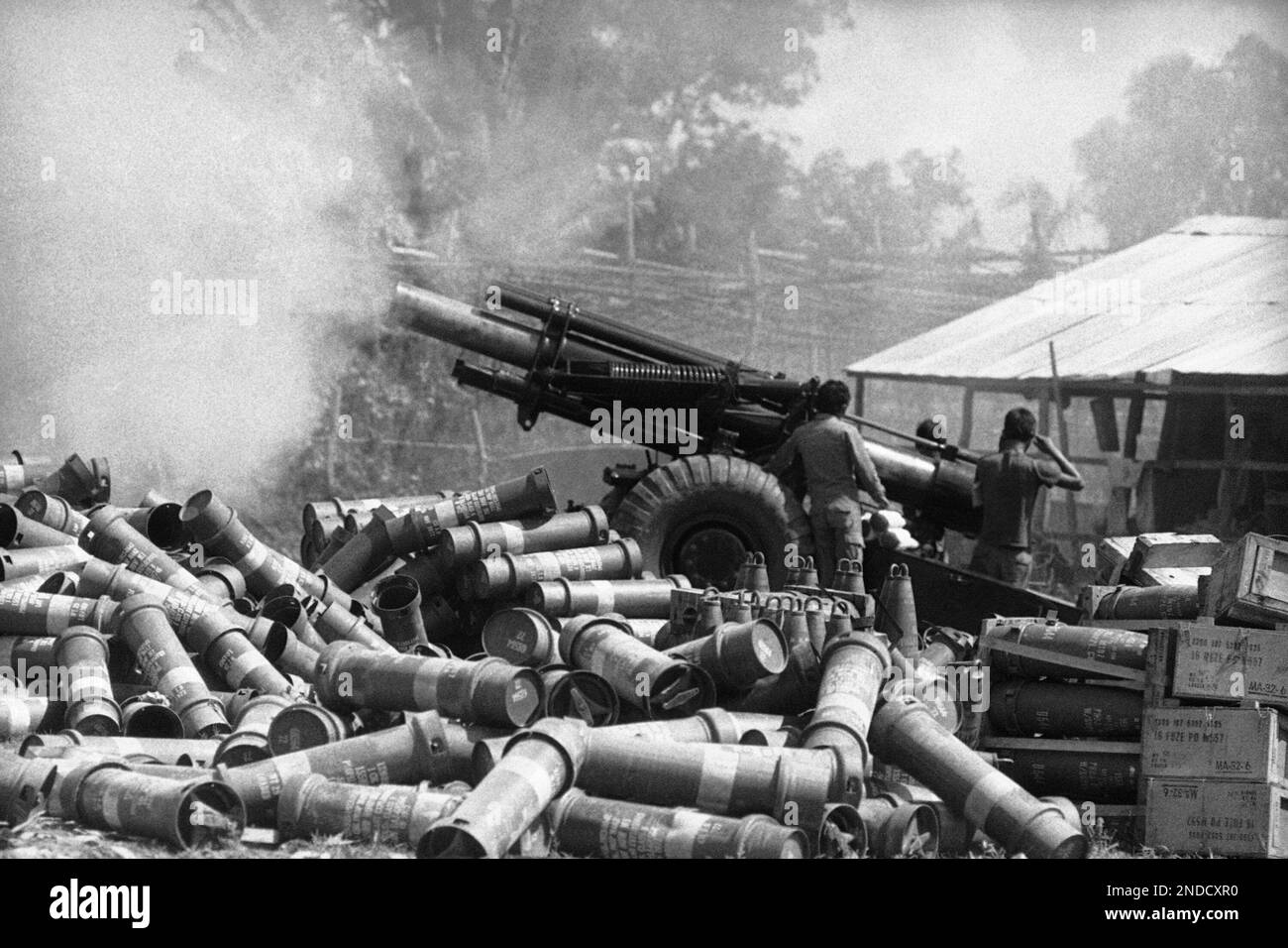 A Cambodian artilleryman shoves his fingers in his ears as his 155mm ...