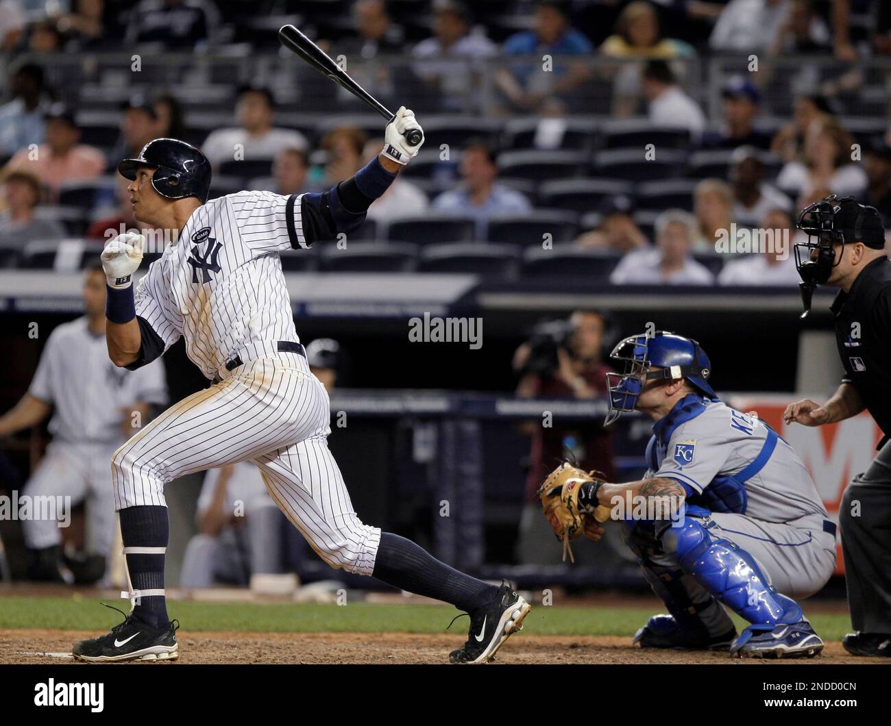 New York Yankees' Alex Rodriguez follows through on a solo home run as ...