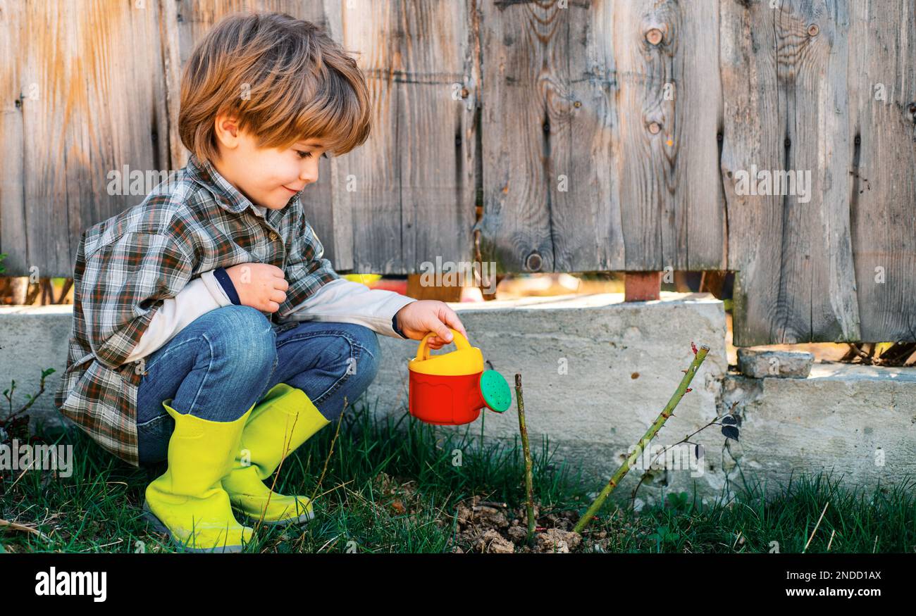 CHild with Shovel and watering can. Carefree childhood. Farming and ...