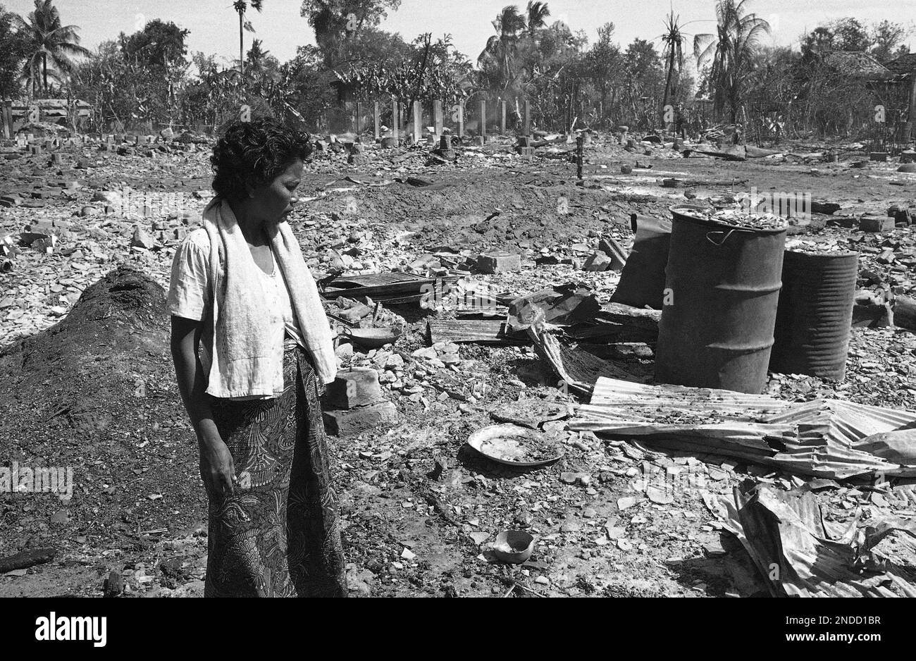 Ton Pek Sadly surveys remains of her shop on Dec. 10, 1971, that was ...