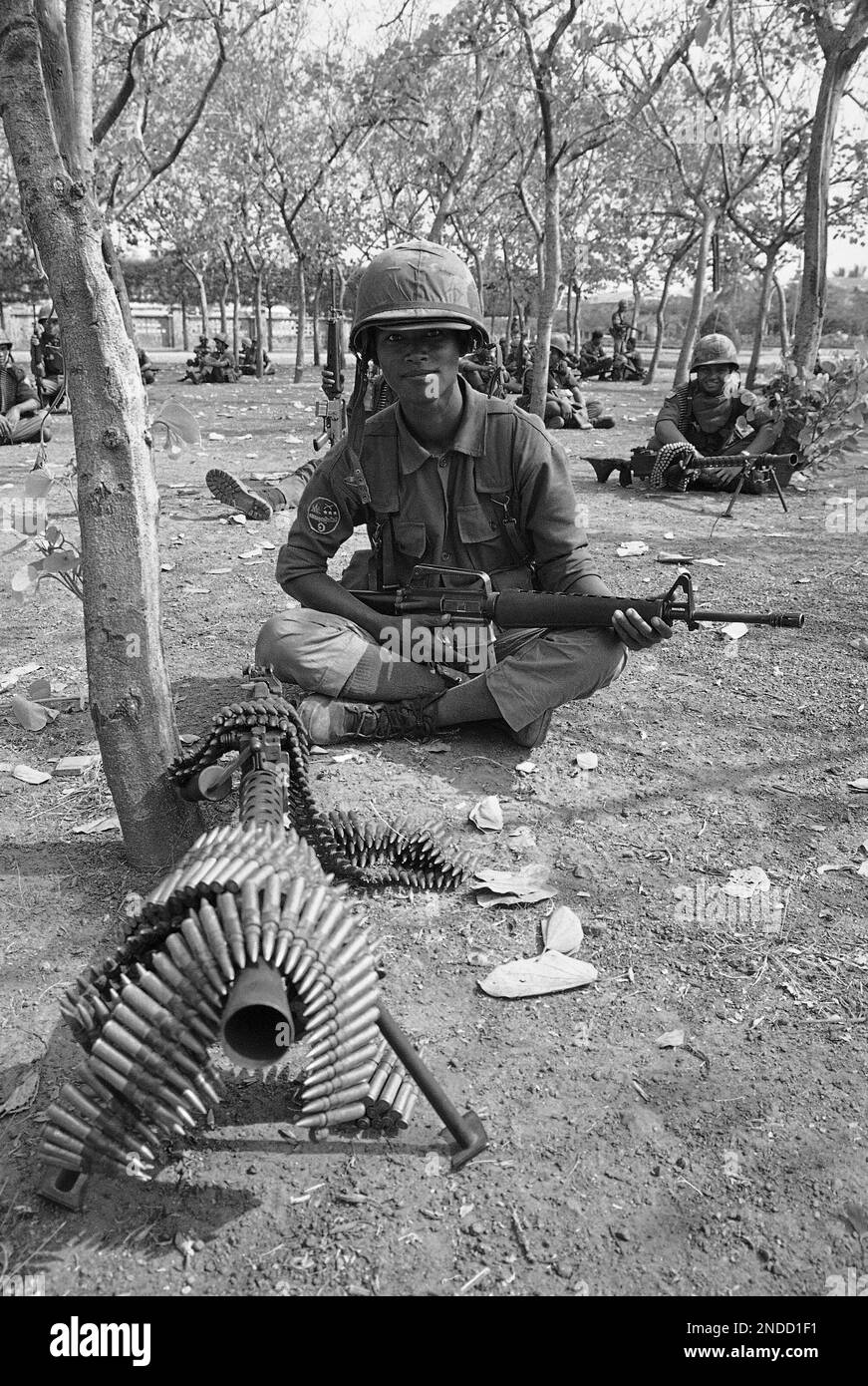 A heavily-armed Cambodian soldier sits in a park near the National ...