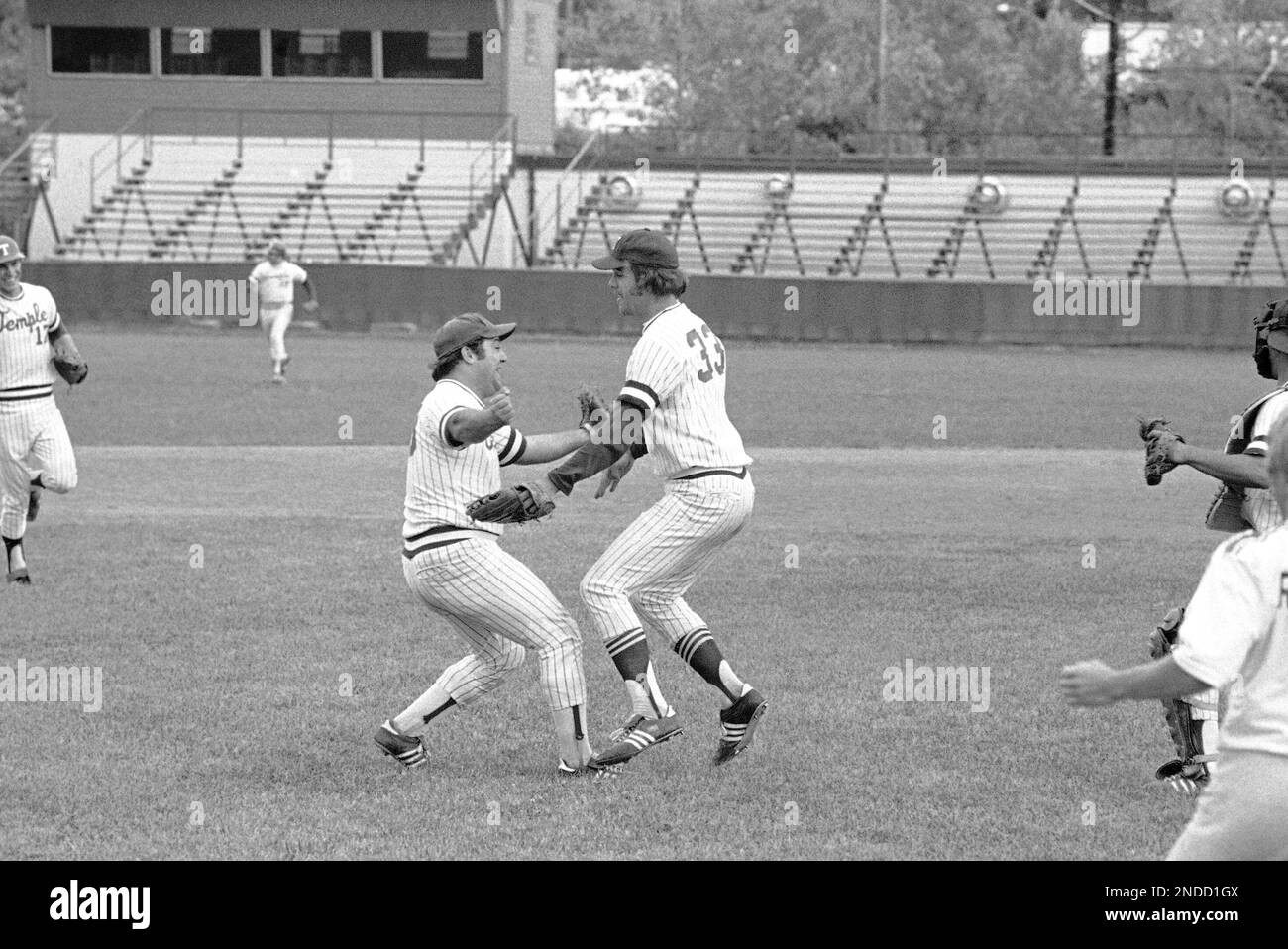 Temple University third baseman John McArdle, left, runs to hug Temple ...