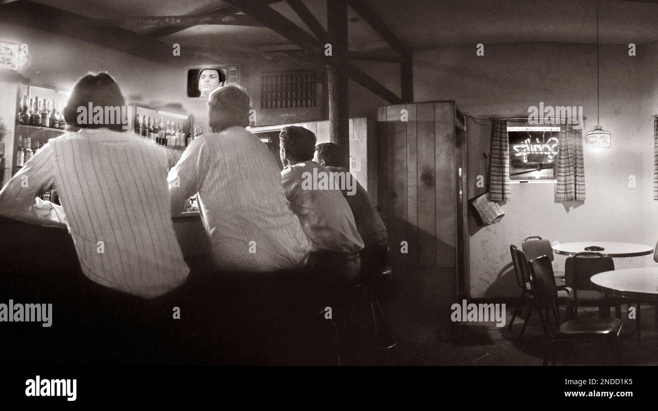 Men at the bar in Sidney, Montana watching boxer Muhammed Ali on TV ...