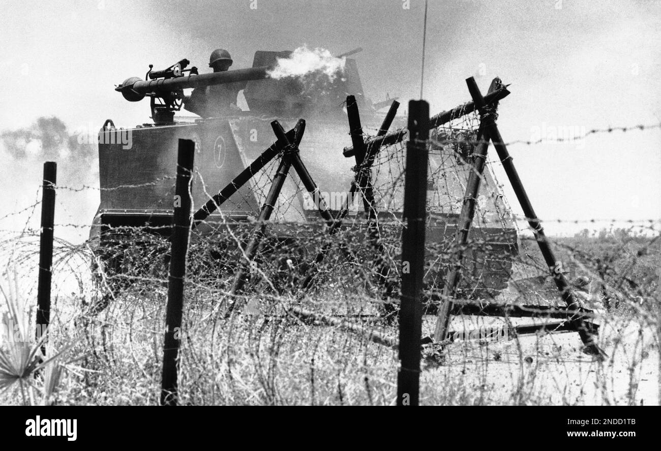 Flames spurt from recoilless rifle mounted on a Cambodian armored ...