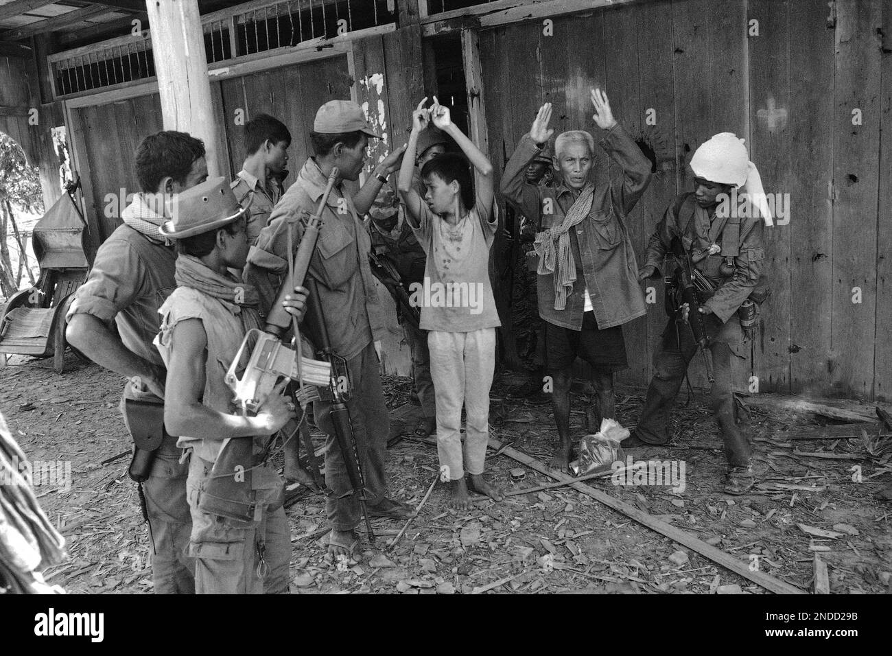 A boy and his father stand with raised arms after being captured by ...