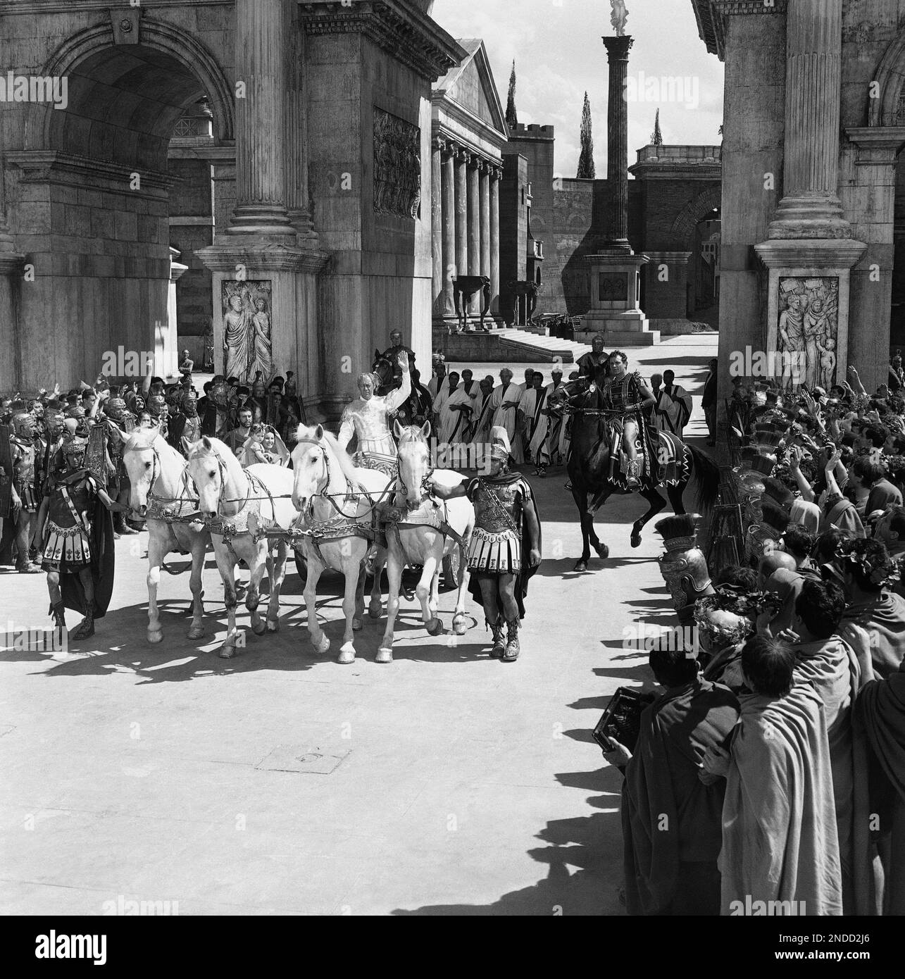 British actor Rex Harrison as Julius Caesar rides a gilded chariot ...