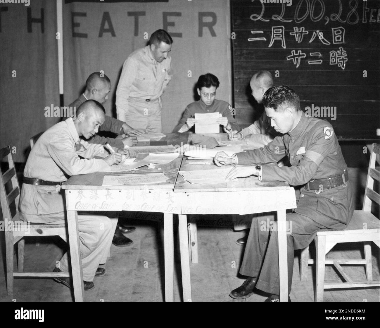 Lt. Col. A.J. Hart, San Antonio, Texas, standing confers with Chinese ...