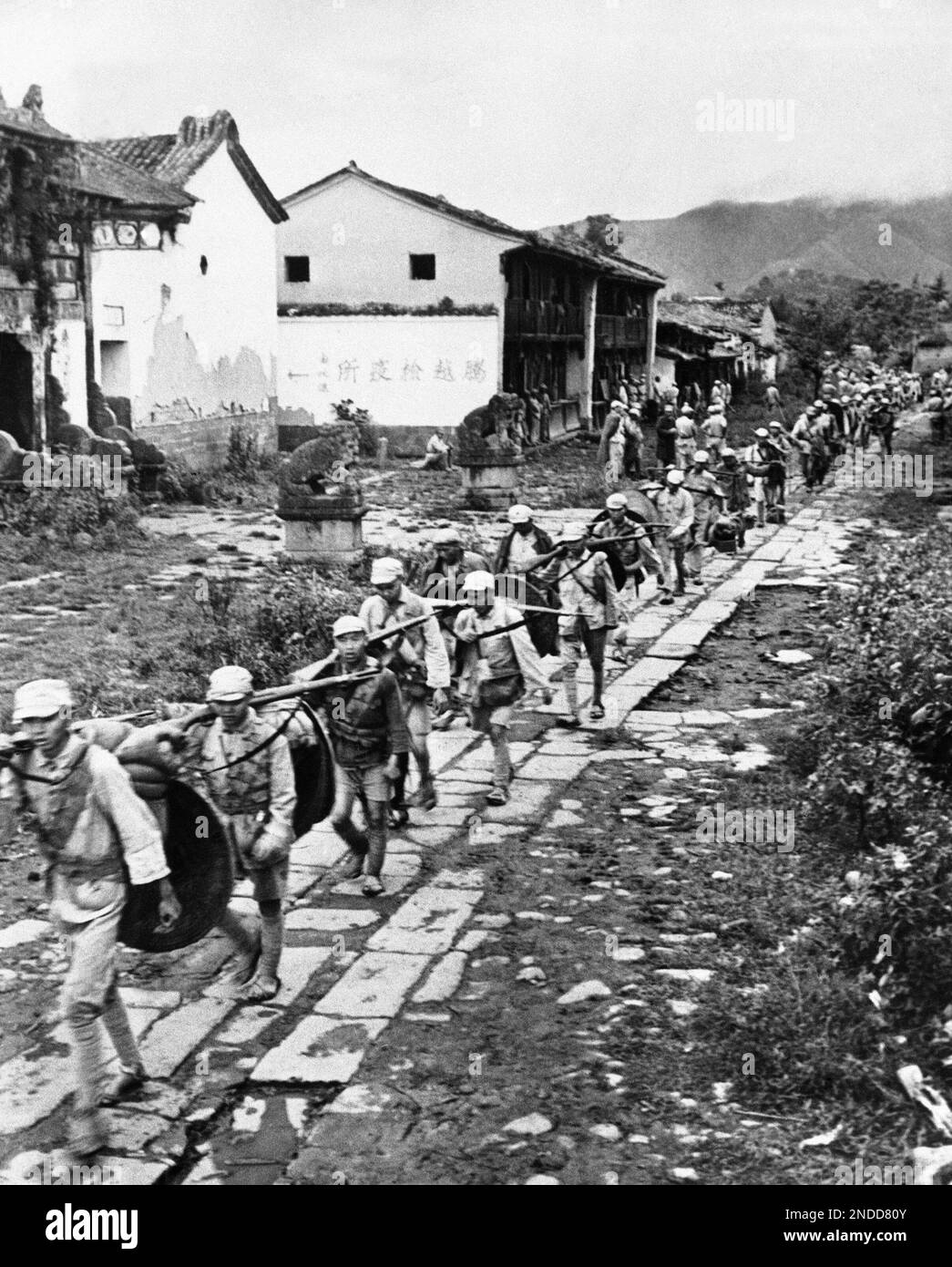 Chinese troops file through a street in Tengchong, China, on Oct. 15 ...