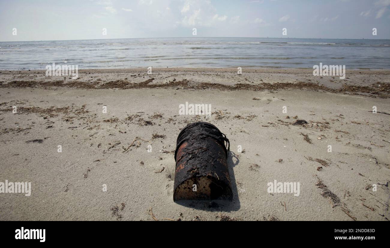 In a Monday, June 21, 2010 photo, a bucket covered in oil from the ...