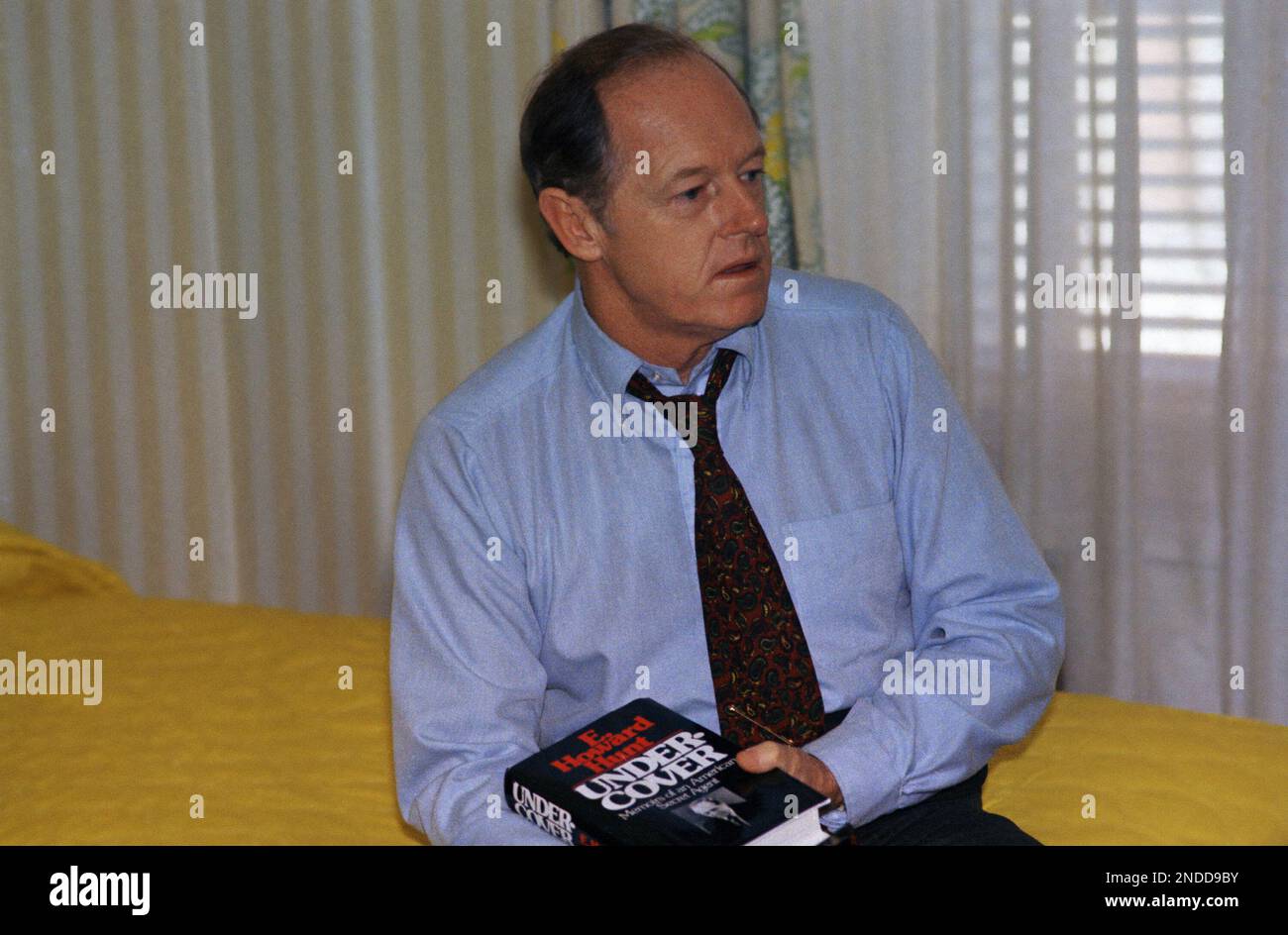 Watergate conspirator E. Howard Hunt, holding his book “Under Cover” on ...