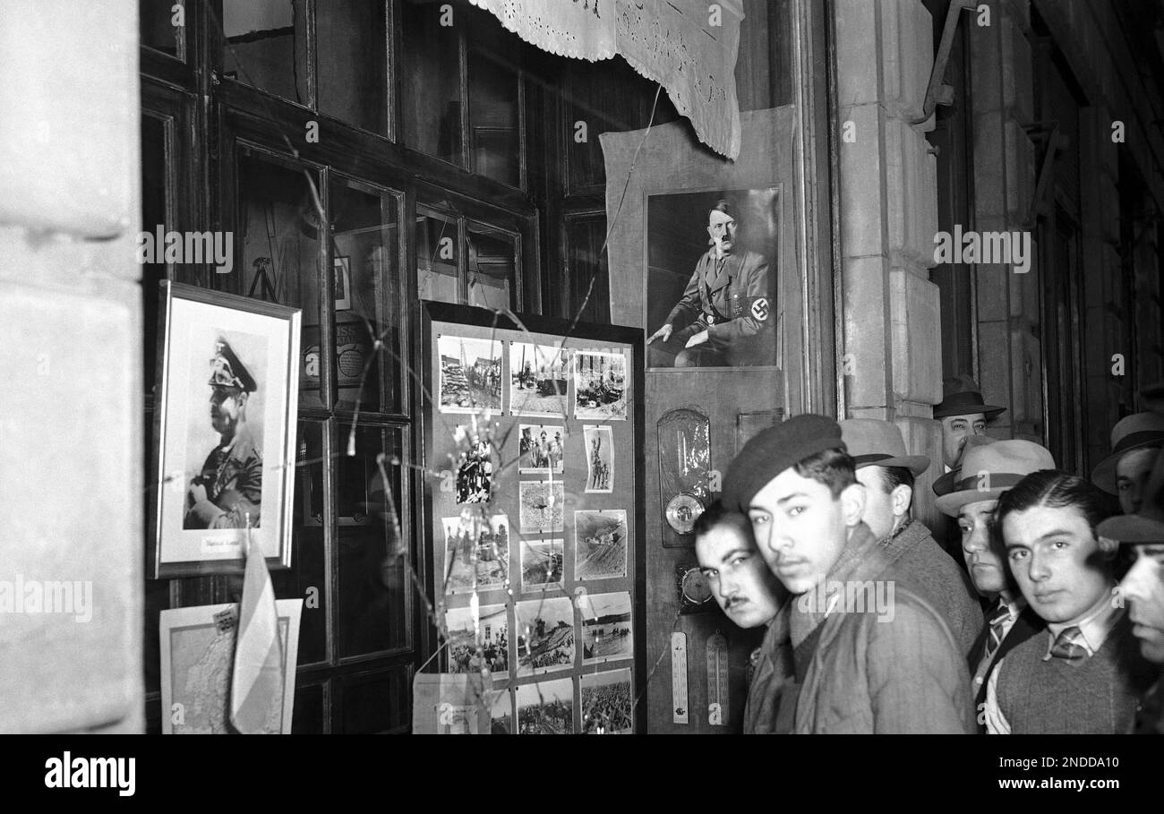 A crowd of Argentines gather around the show window of a German-owned ...