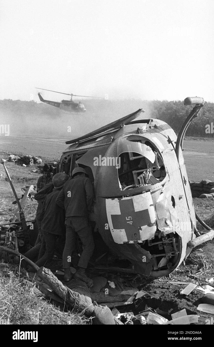South Vietnamese troops look inside U.S. army medivac helicopter that ...