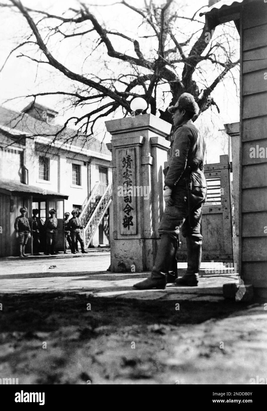 A Japanese sentry stands guard in front of field headquarters at Aigun ...