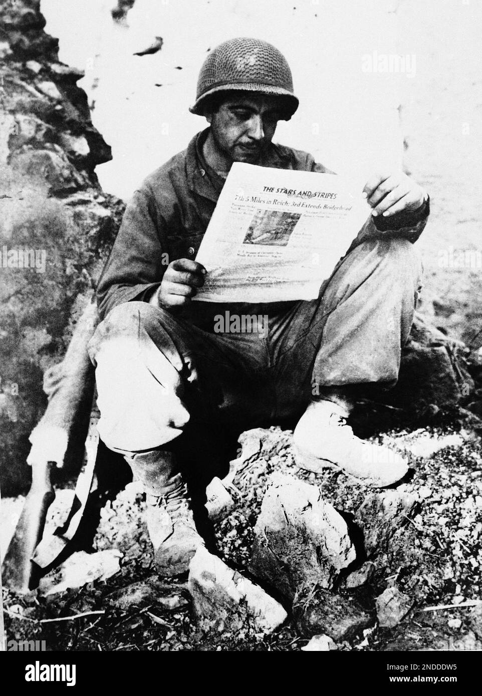 World-War II-sitting in a rubble of a doorway infantryman pauses during ...