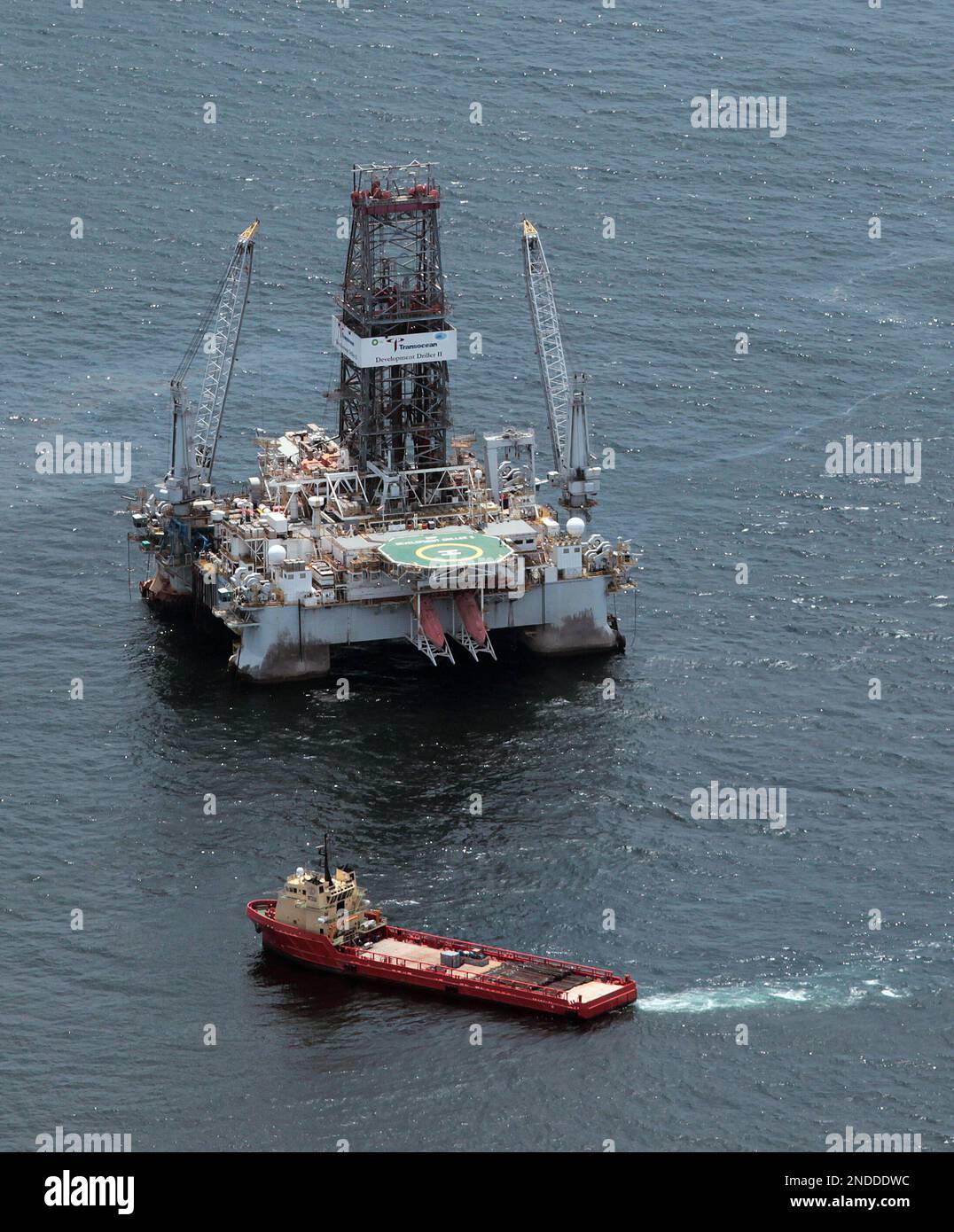 Drilling rigs and workboats operate at the site of the Deepwater ...