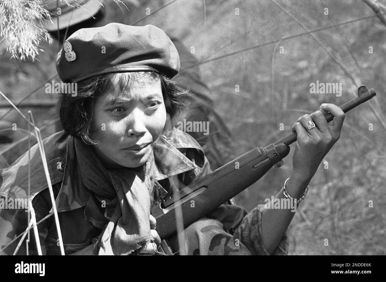 A Cambodian girl soldier clutches her U.S. made carbine while waiting ...