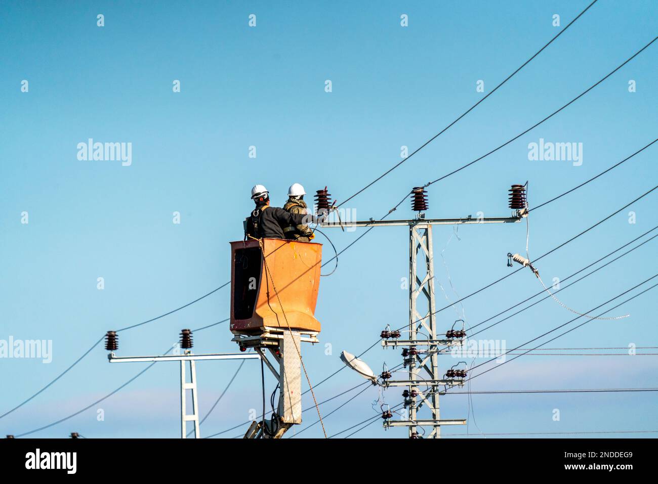 Electrical workers are making a high voltage connection. Electricity ...