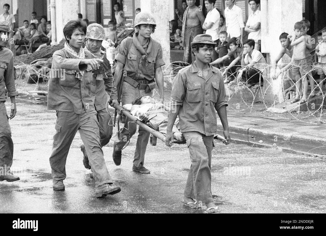 Cambodian medics carry a badly wounded soldier in Cambodia Sept. 27 ...