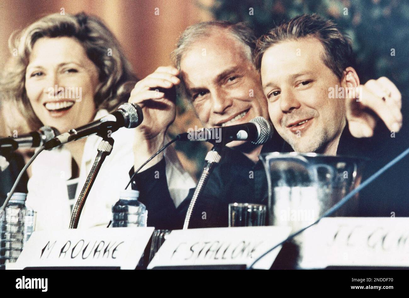 American actor Mickey Rourke, right, points a fingers at newsmen in ...