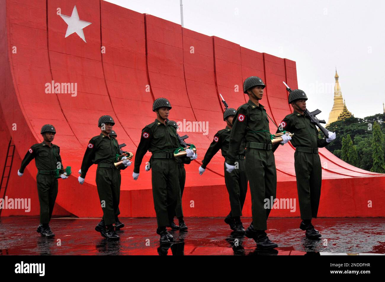 Myanmar soldiers walk past the Mausoleum after saluting the ...