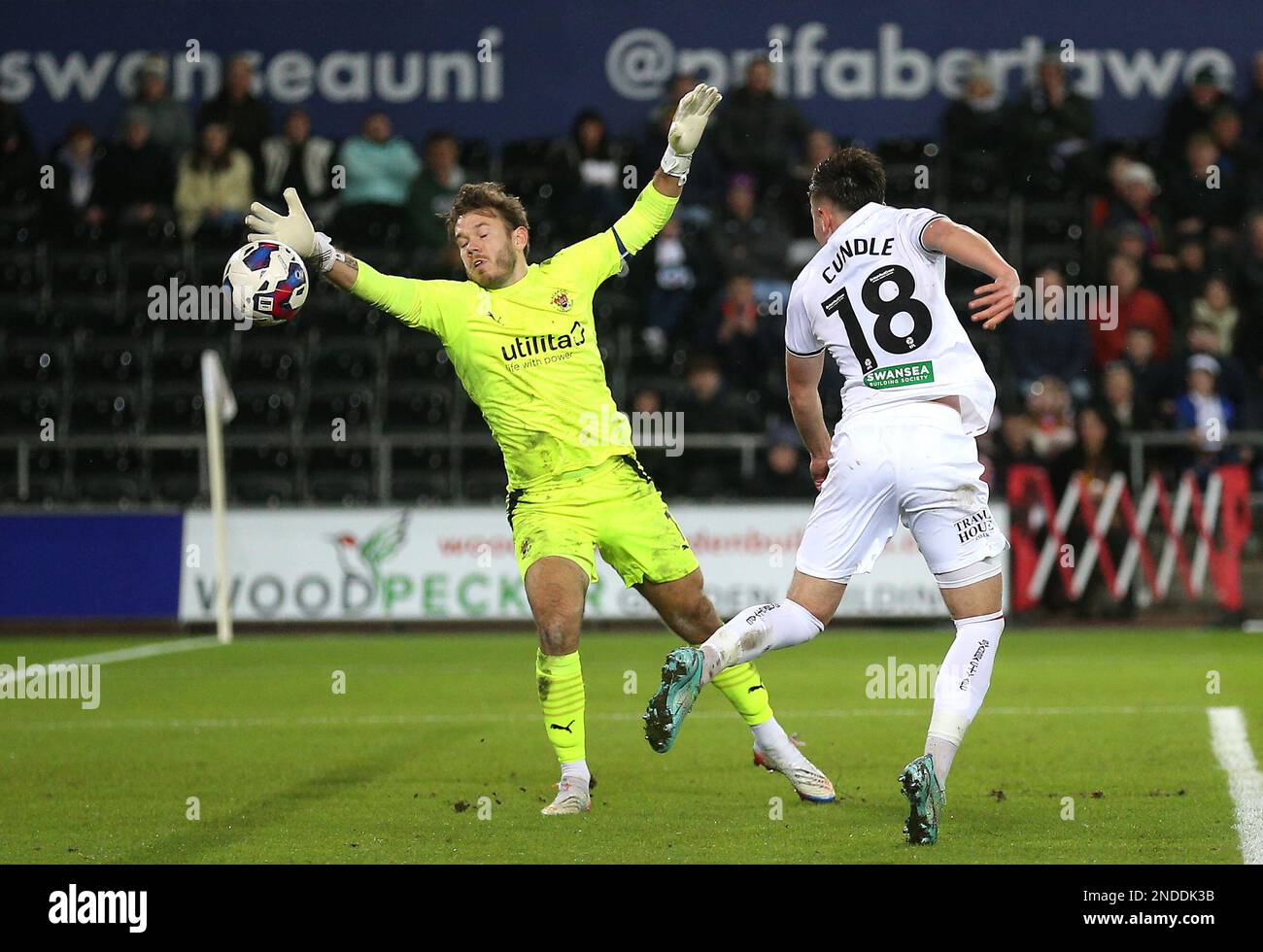Swansea City's Luke Cundle (right) attempts a shot on goal during the ...