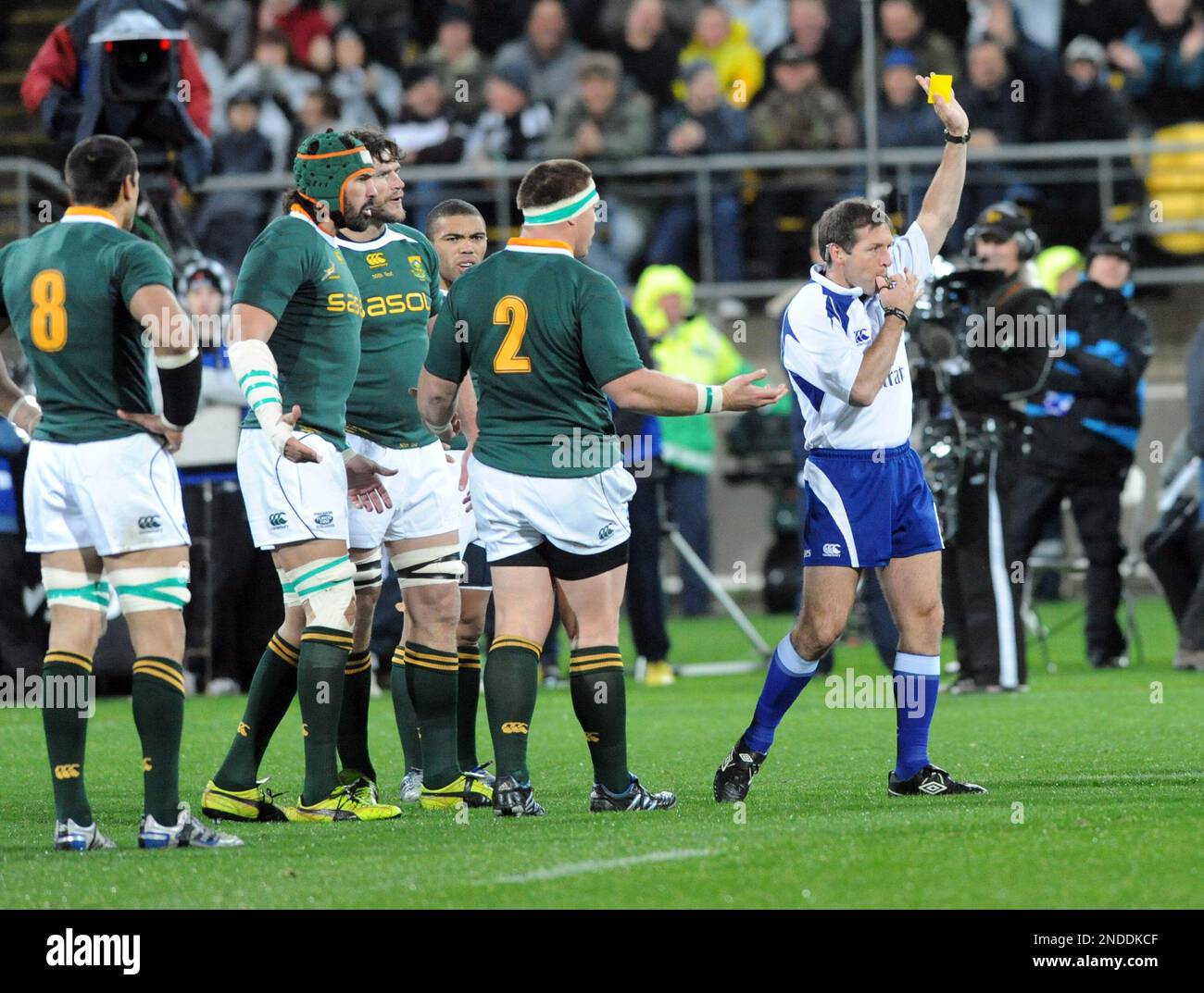 Referee Alain Roland flashes yellow cards at Danie Rossouw, third from ...