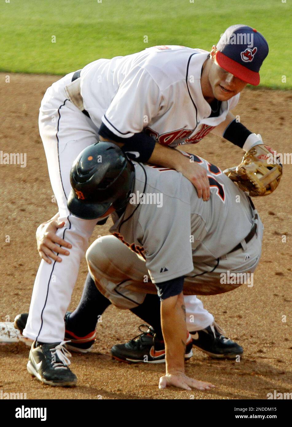 Cleveland Indians second baseman Jason Nix, top, falls over Detroit ...