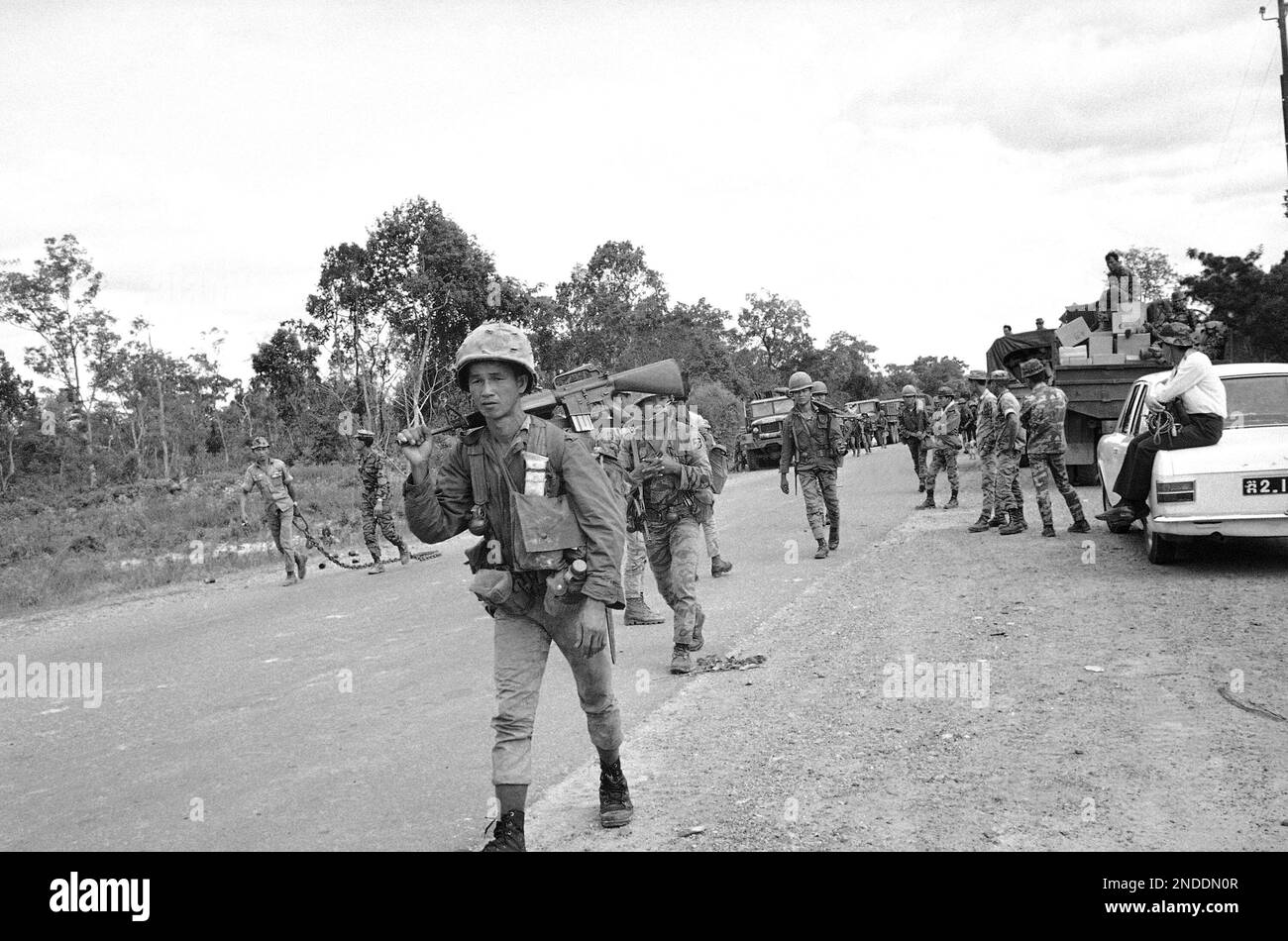South Vietnamese marines walk along route 4 North of Kompong Som ...