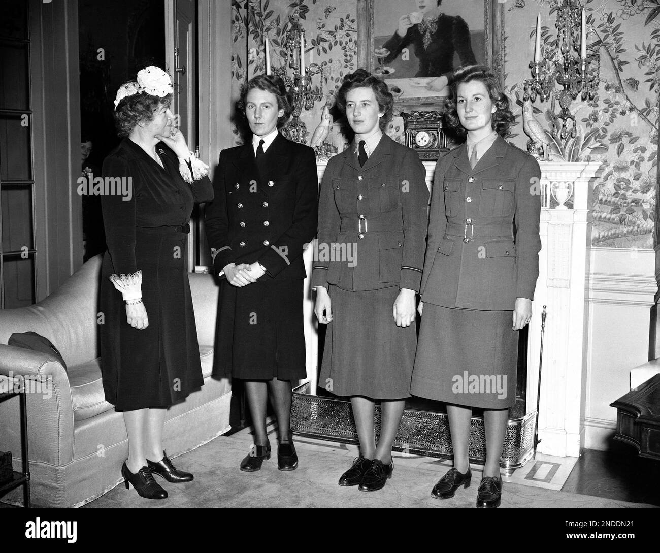 Mrs. Edith Nourse Rogers (R-Mass), left, studies uniforms worn by women ...