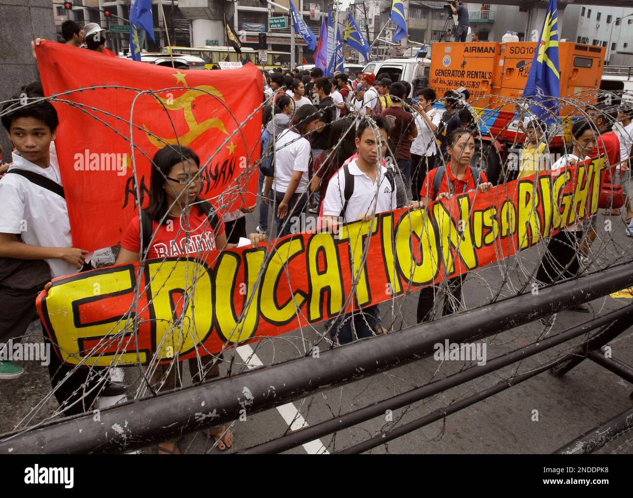 Students holds their streamer in front of a police barricade during a ...
