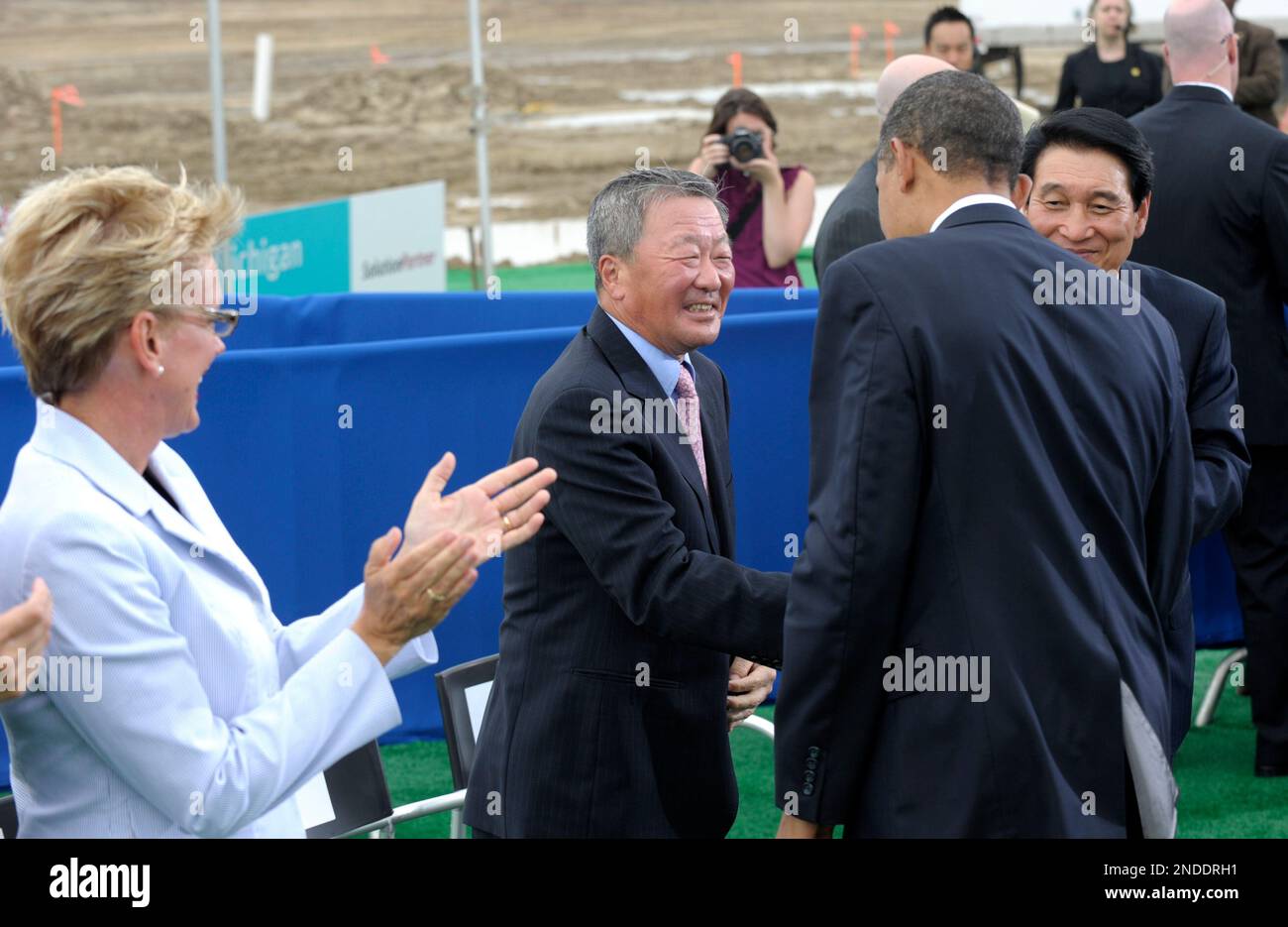 President Barack Obama, second from right, shakes hands with LG Chem ...