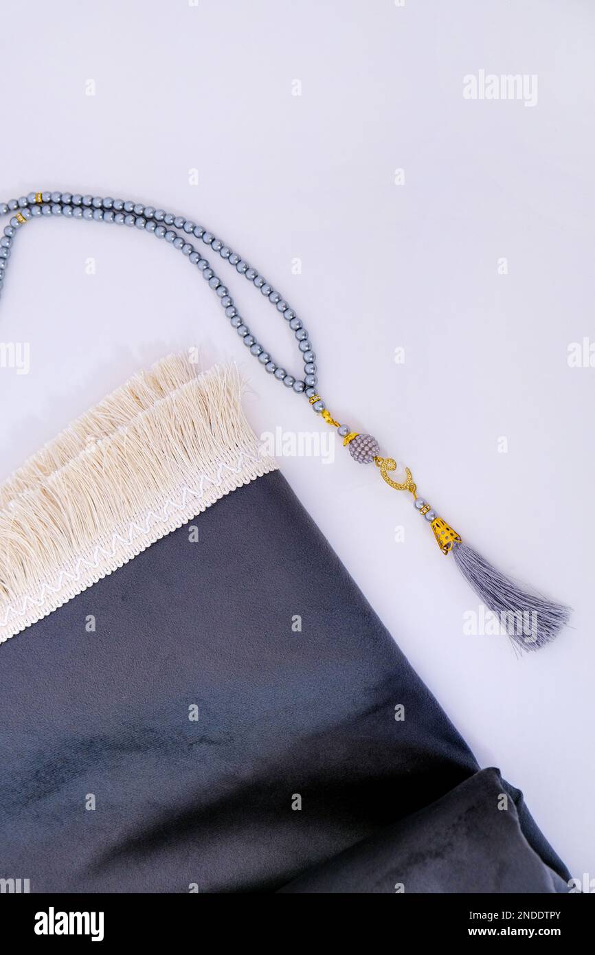 praying mat top view white background. Islamic shop items Stock Photo ...