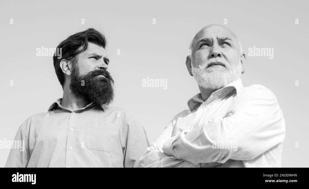 Two men: grandfather and father together. Fatherhood. Grandfather with ...