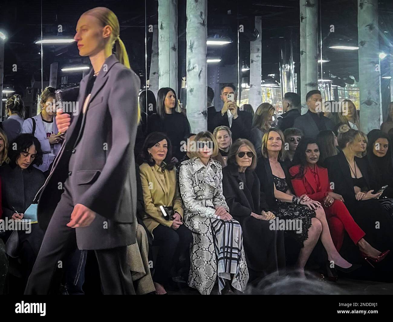 Vogue editor-in-chief Anna Wintour, center, wear dark glasses while ...