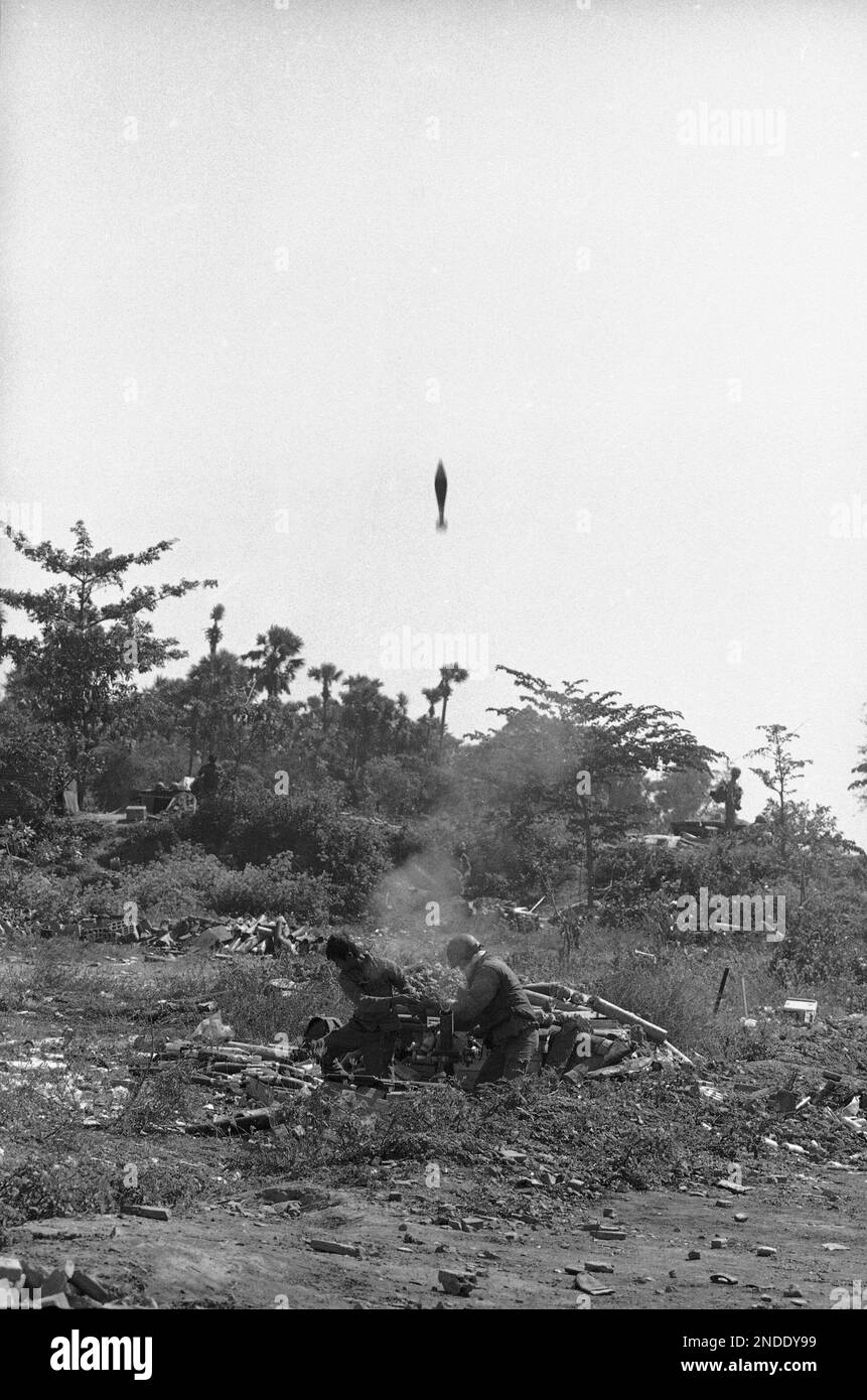 An 82mm shell flies from a mortar tube in government trench along Rte ...