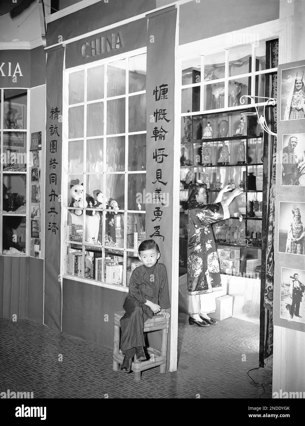 Six year old William Lum sits outside the United China Relief Shop of ...