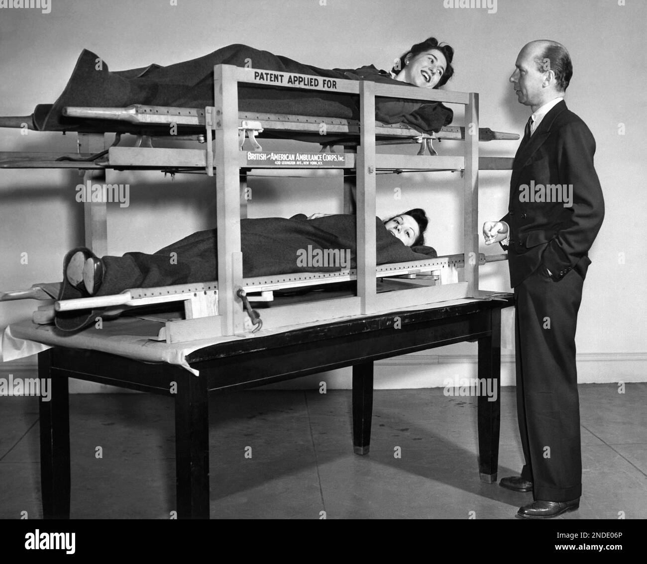 The two-stretcher cradle is use, William V. C. Ruxton, designer, poses ...