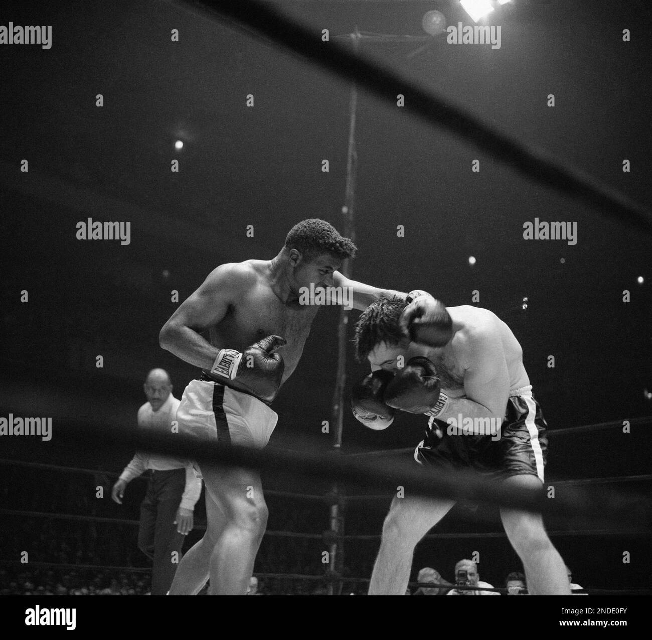 Floyd Patterson drives a long right behind the head of George Chuvalo ...