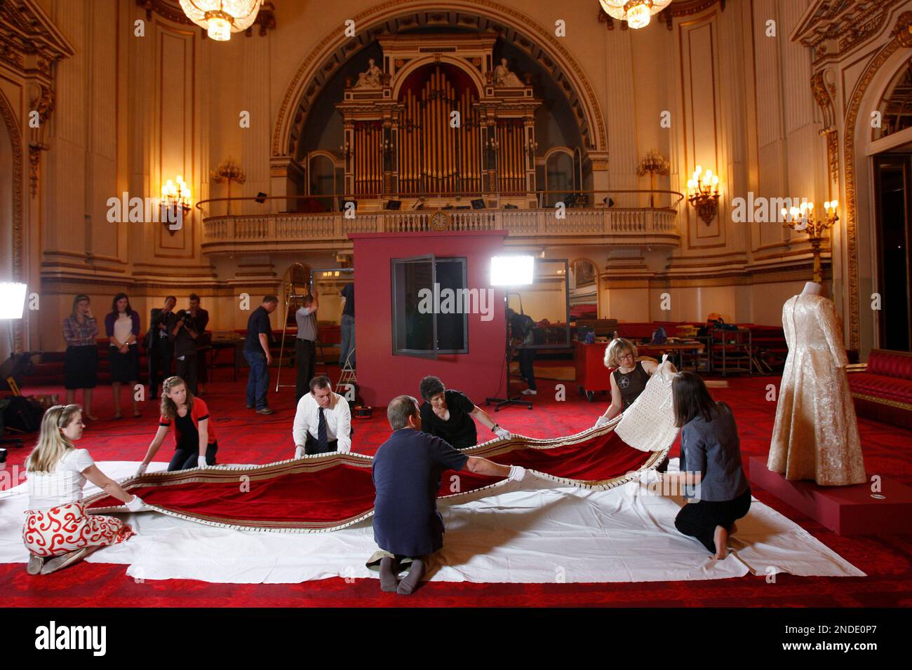 Members of staff prepare for public display, the Robe of State used by ...