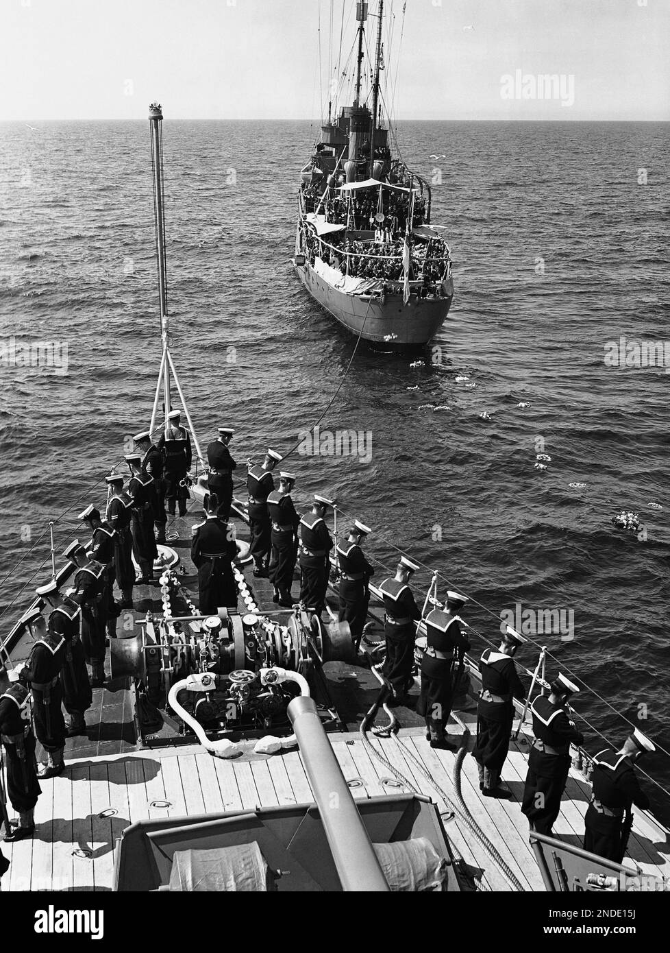 Wreaths are thrown into the sea during a memorial service for the ...