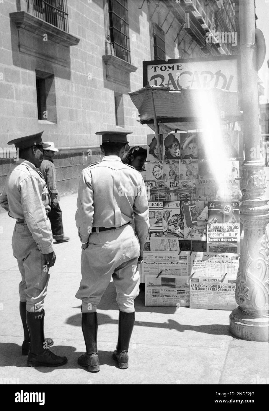 Mexican soldiers pause before a news stand in Mexico City on May 31 ...