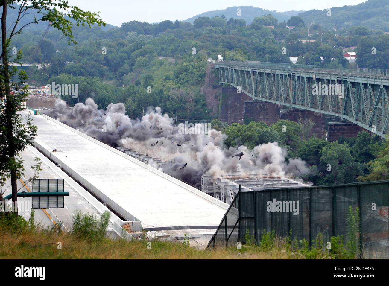 Flying debris and a dust cloud can be seen from Oakmont, Pa., as it ...