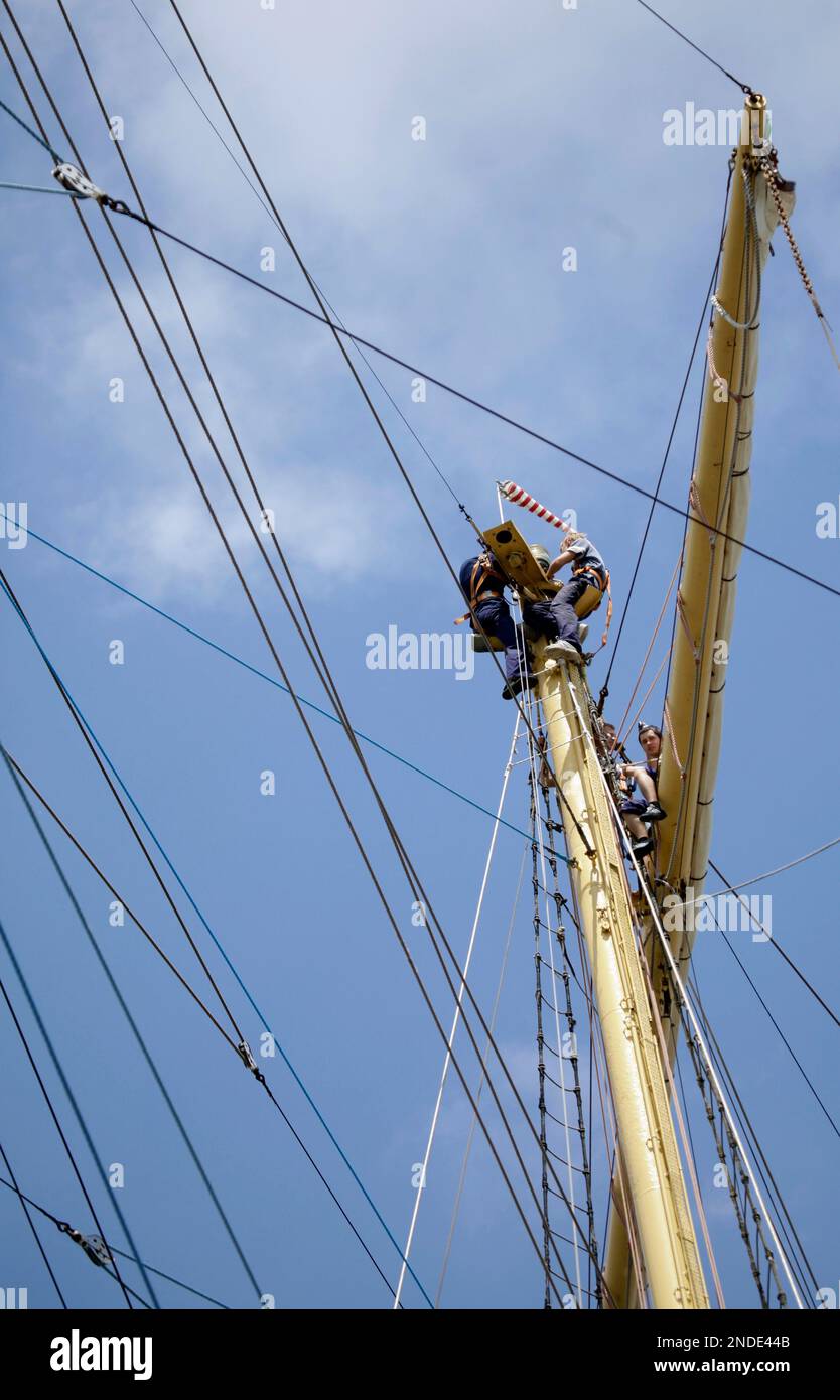 Sailors sit in the 'crows nest' aboard the Russian tall ship Mir moared ...