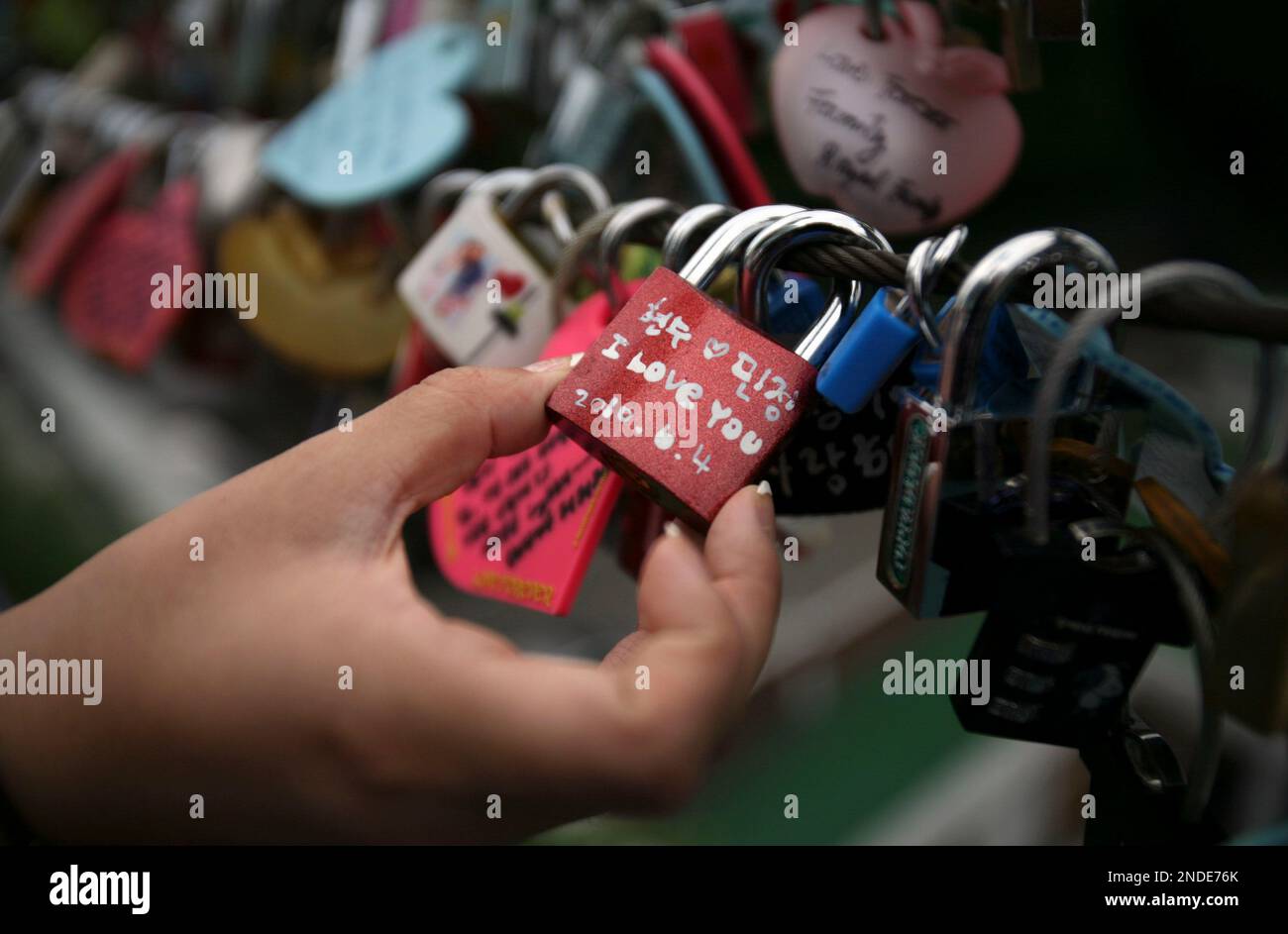 In this June 13, 2010 photo, a woman reads the note on a pad lock that ...
