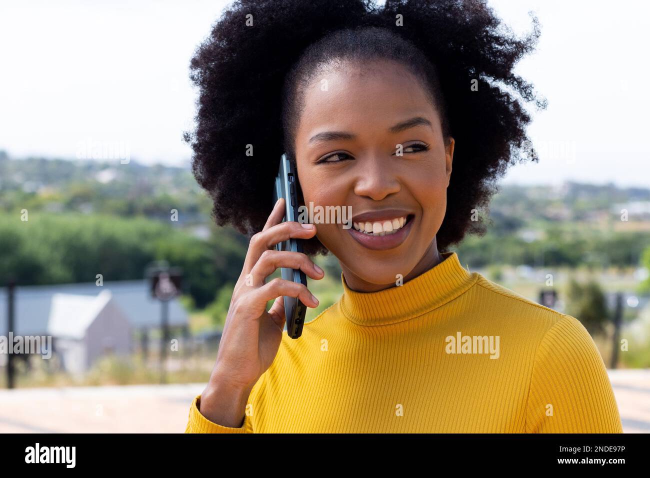 Happy african american businesswoman walking and talking on smartphone ...